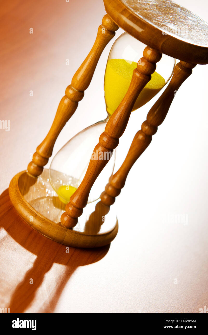 Time concept with hourglass on wooden background Stock Photo - Alamy