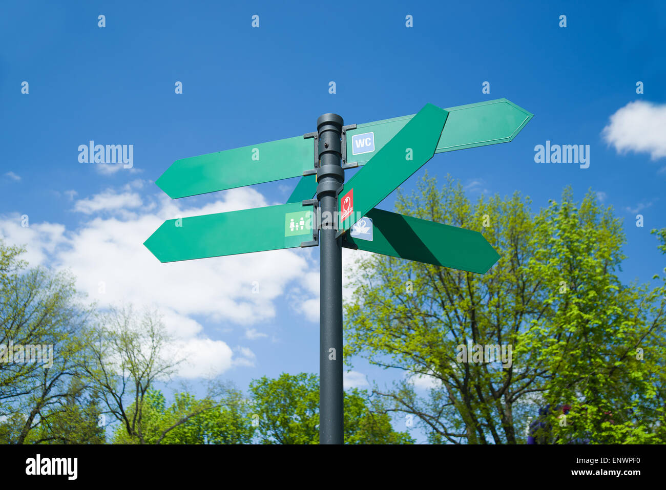 The sign indicate the direction in the park against the sky Stock Photo ...