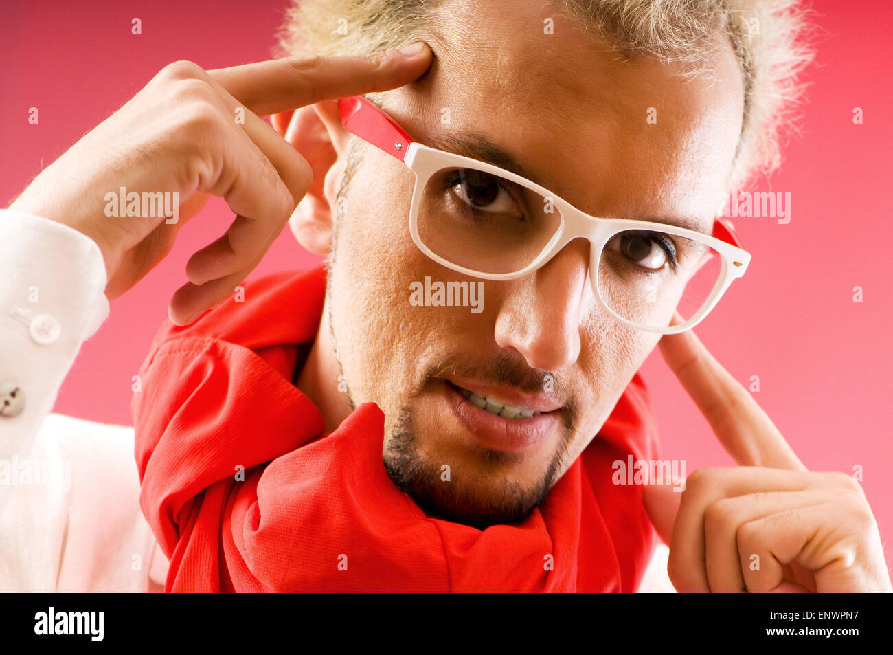 Man with red scarf against coloured background Stock Photo - Alamy