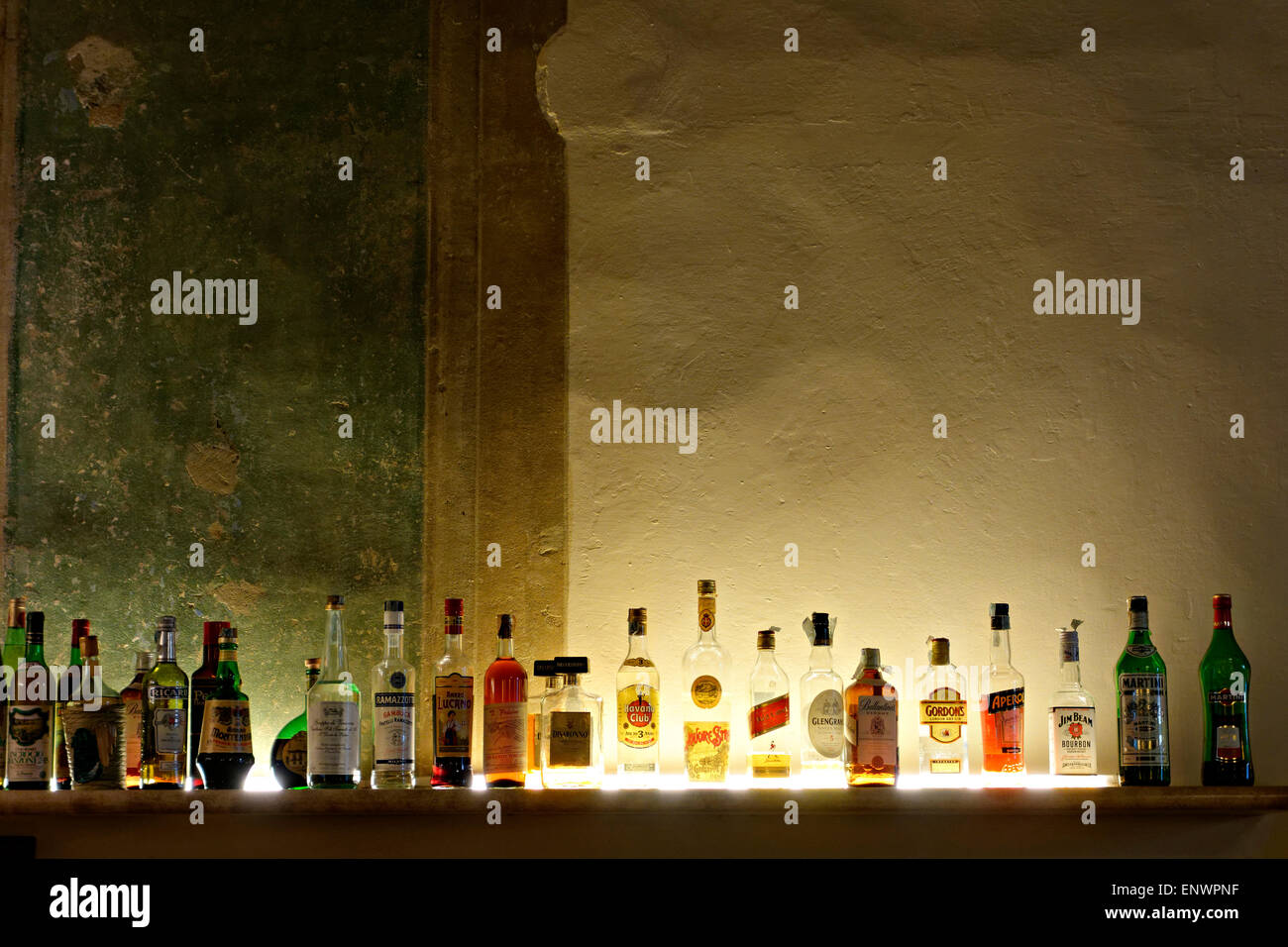 Line of spirit bottles on bar shelf Stock Photo - Alamy