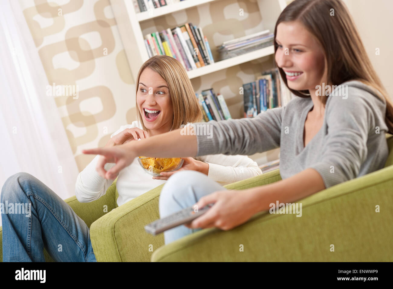 Students - Two smiling female teenager watching television Stock Photo ...