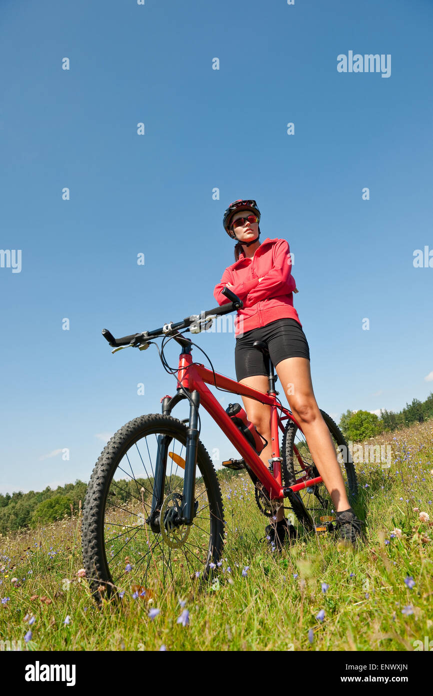 Young woman with mountain bike in spring nature Stock Photo - Alamy