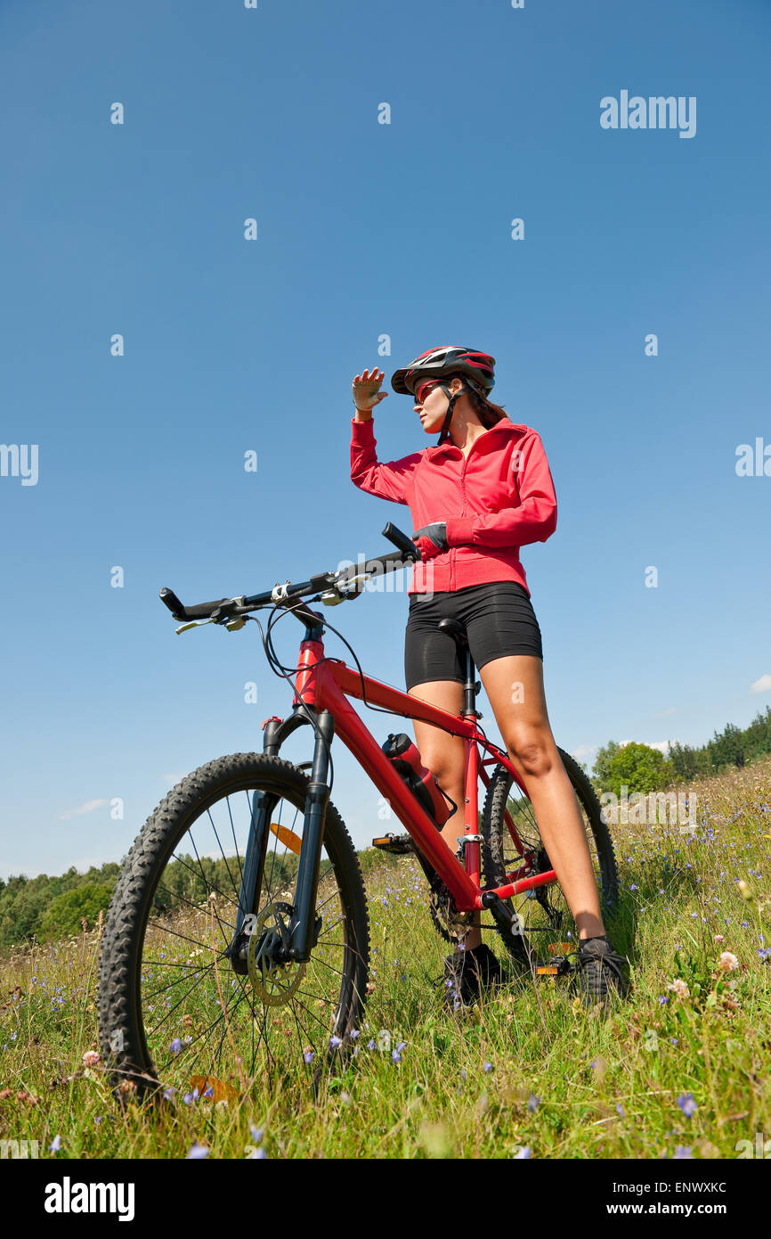 Young woman with mountain bike in spring nature Stock Photo - Alamy