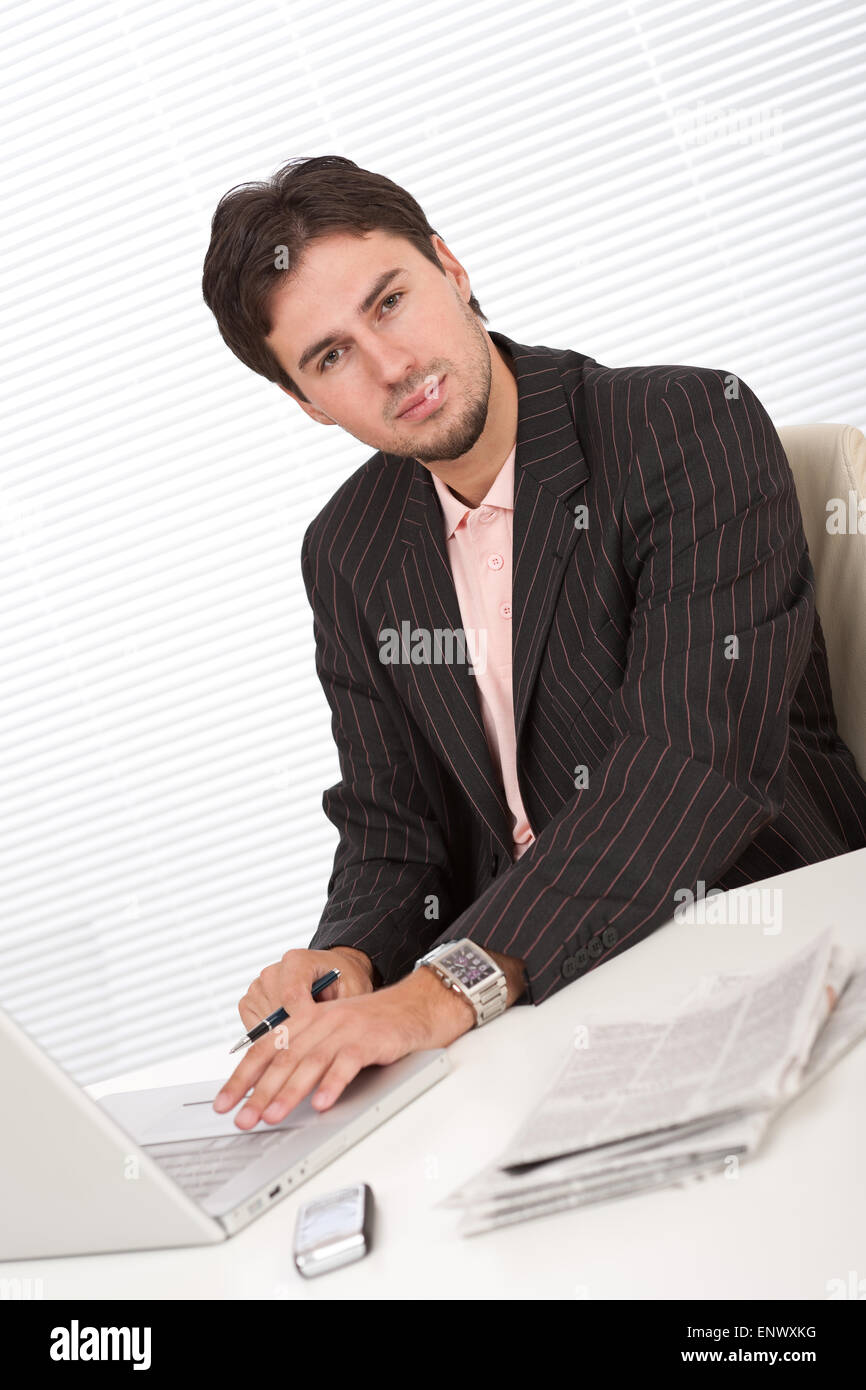 Successful modern businessman with laptop and newspaper Stock Photo - Alamy