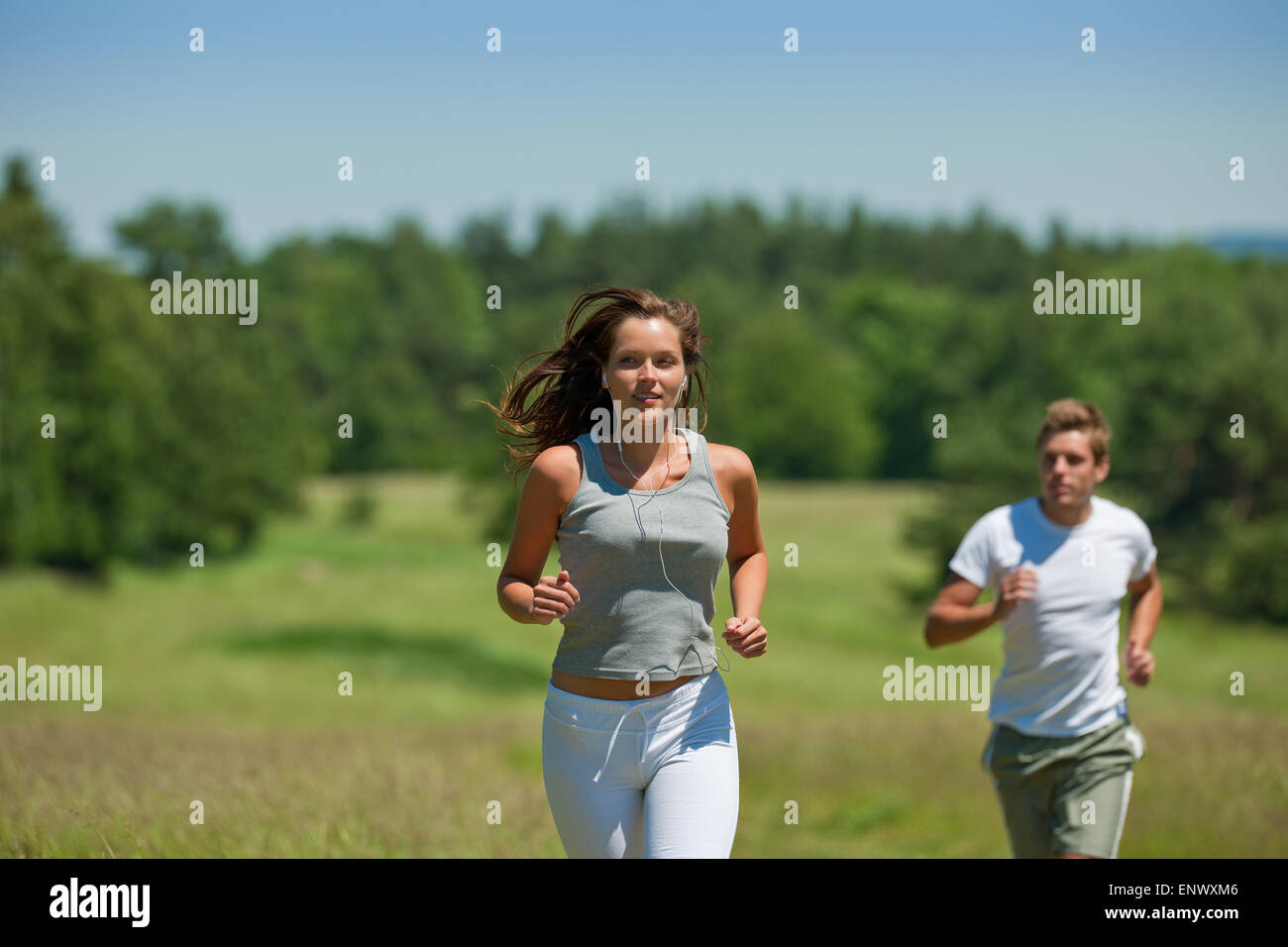 Young couple jogging outdoors in spring nature Stock Photo - Alamy