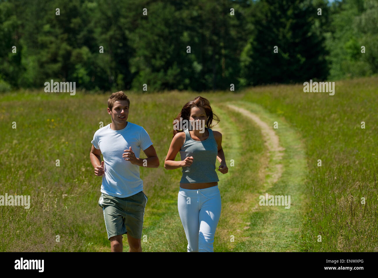 Young couple jogging outdoors in spring nature Stock Photo - Alamy