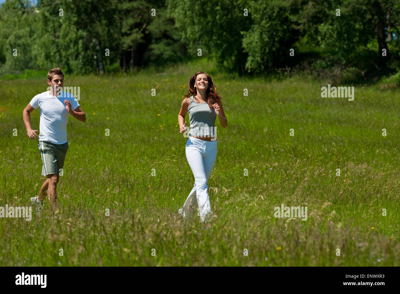 Young couple jogging outdoors in spring nature Stock Photo - Alamy