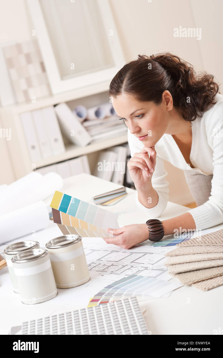 Young female interior designer at office with paint Stock Photo - Alamy