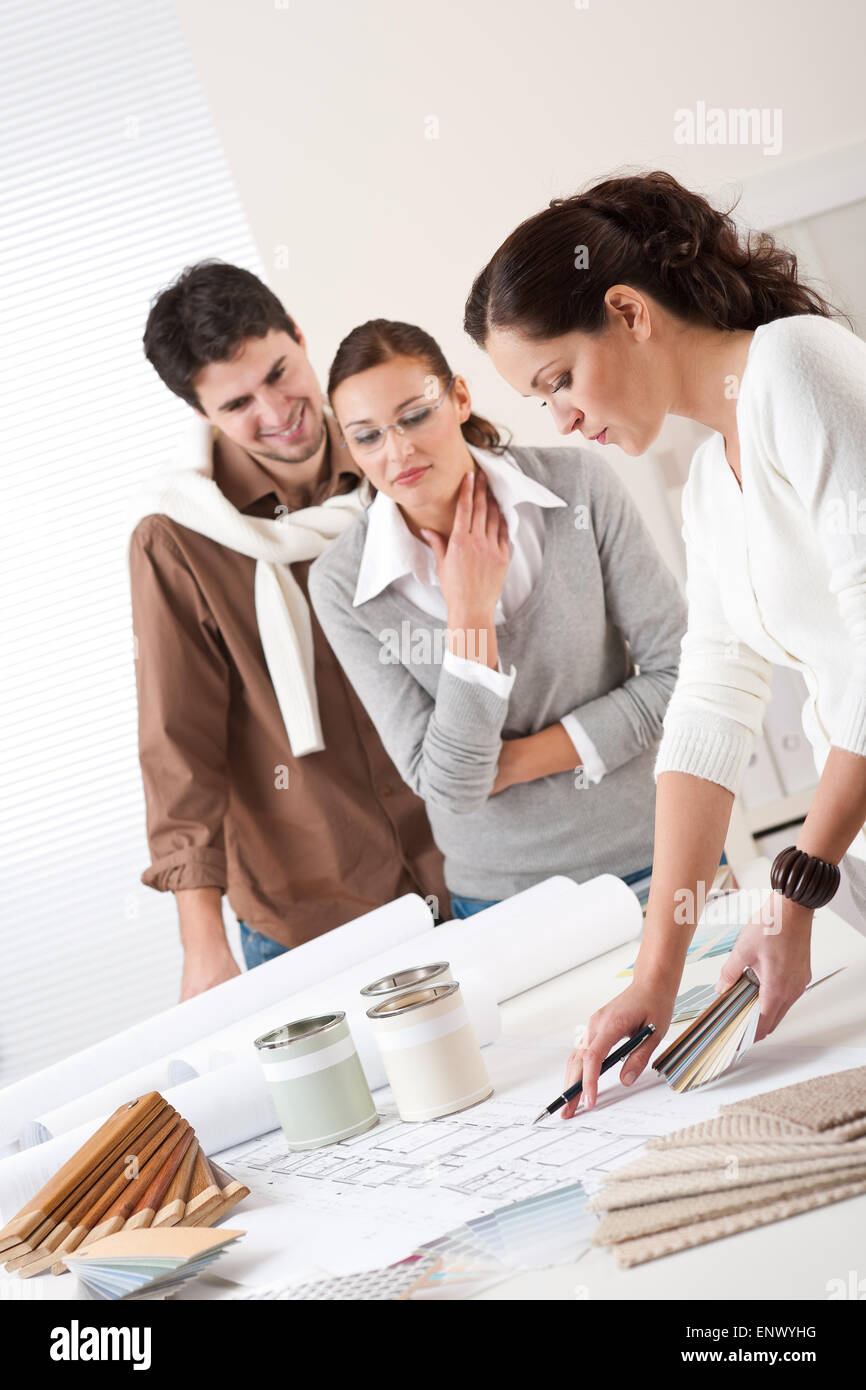 Female interior designer with two clients at office Stock Photo - Alamy