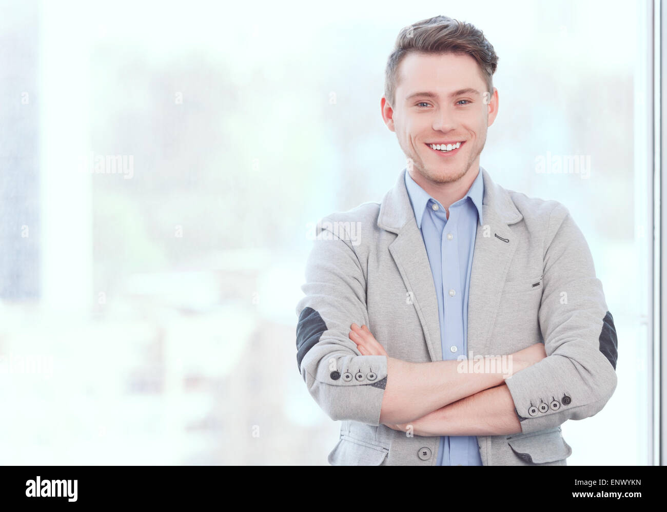 Portrait of young smiling businessman Stock Photo - Alamy