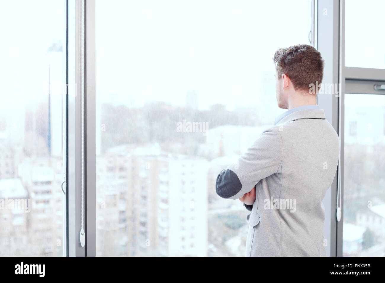 Portrait of man looking in window Stock Photo - Alamy