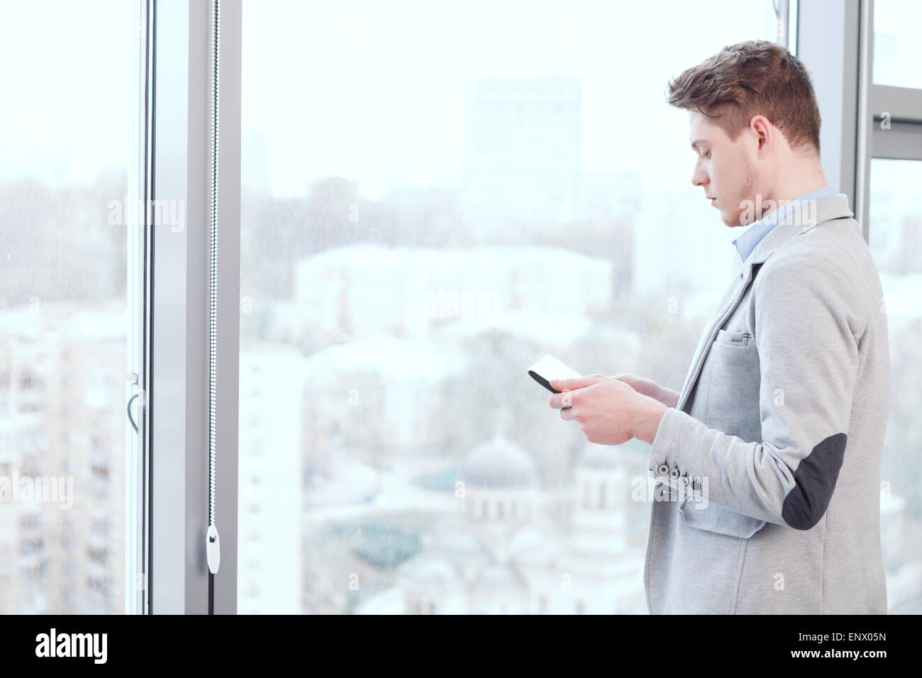 Young man standing with tablet Stock Photo - Alamy