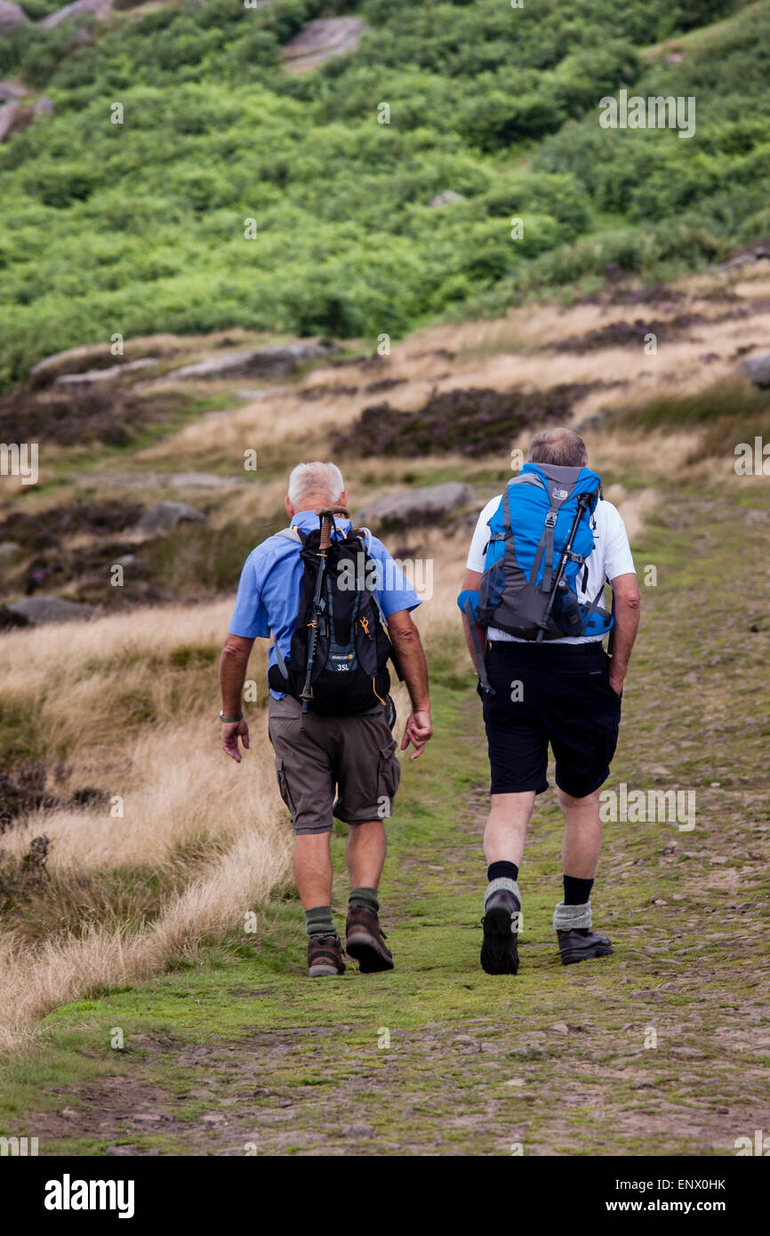 Two elderly walkers with backpacks in the Peak District Stock Photo - Alamy