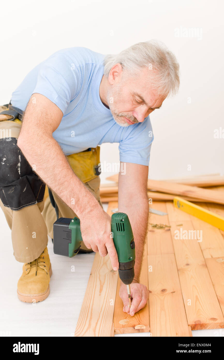 Home improvement - handyman installing wooden floor Stock Photo - Alamy