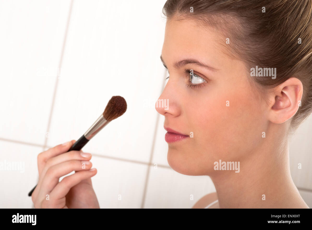Body care series - Young woman applying powder Stock Photo - Alamy