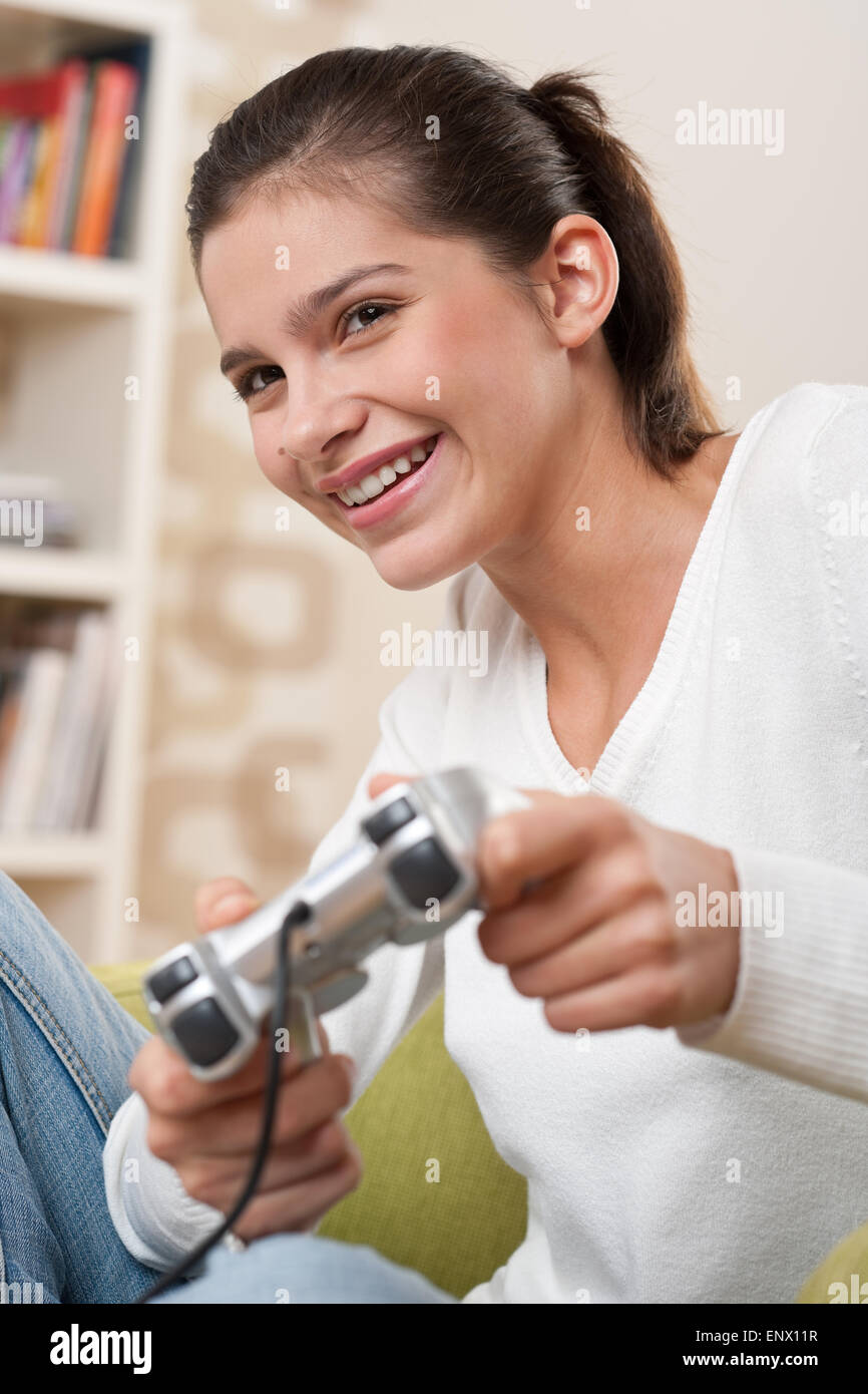 Students - Female teenager playing video game Stock Photo - Alamy