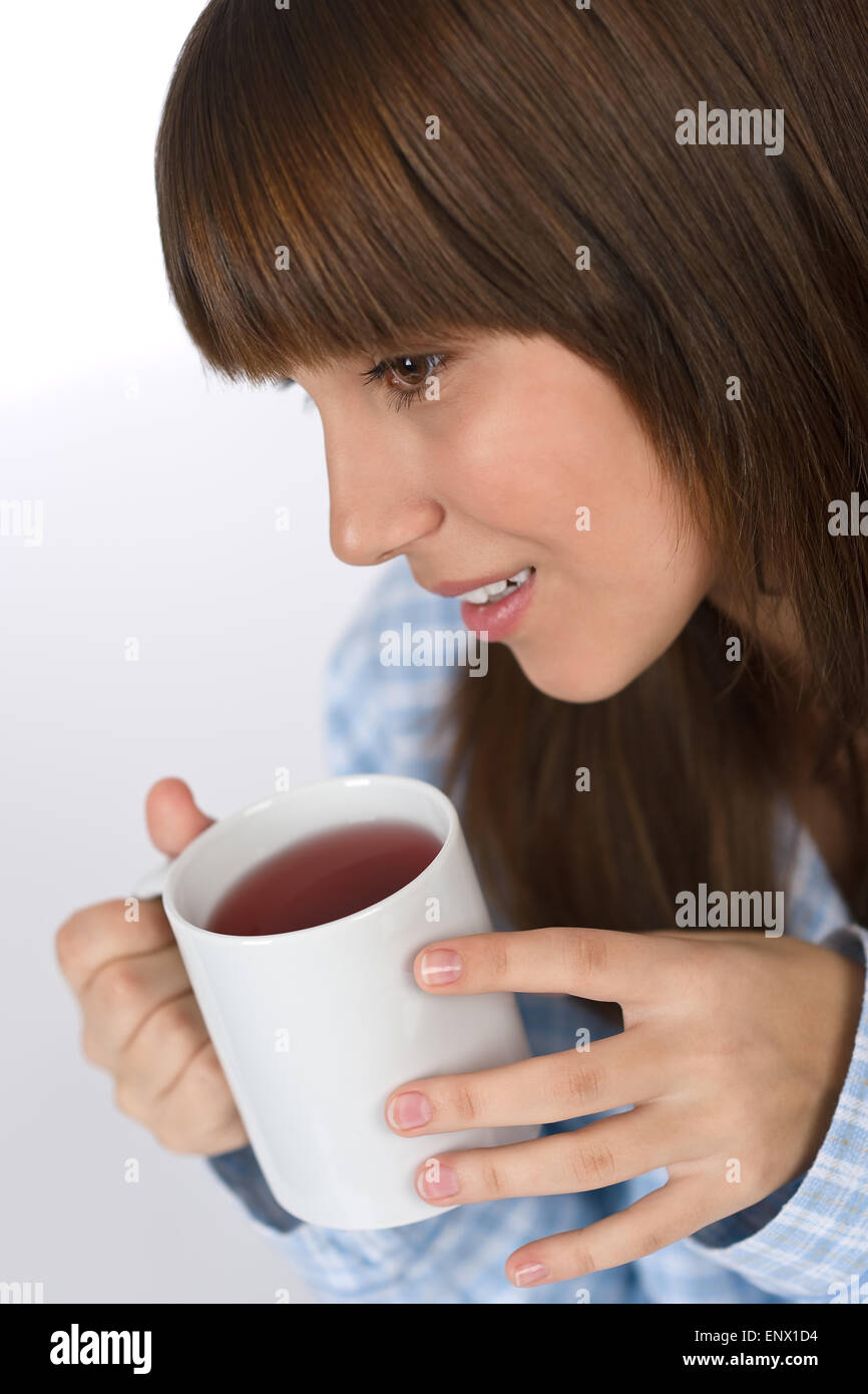 Female teenager with cup of tea for breakfast Stock Photo - Alamy