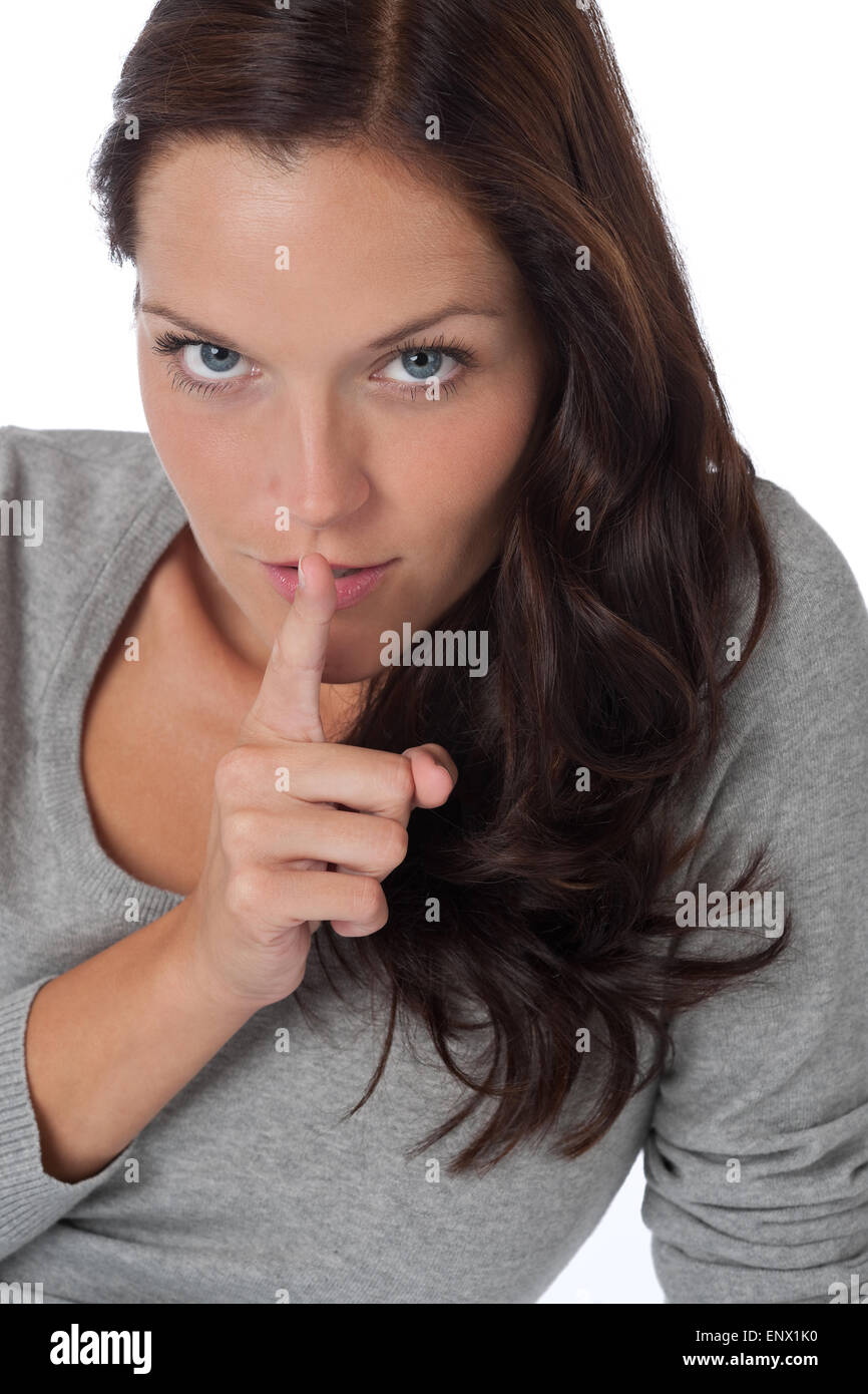 Beautiful woman expressing silence, finger on lips Stock Photo - Alamy