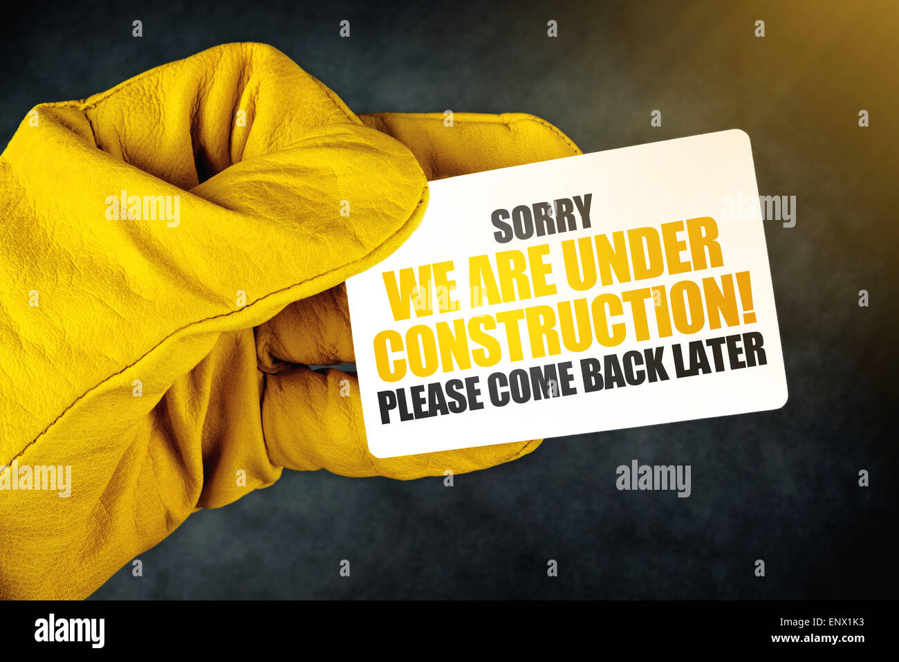 Under Construction on Business Card, Male Hand in Yellow Leather ...