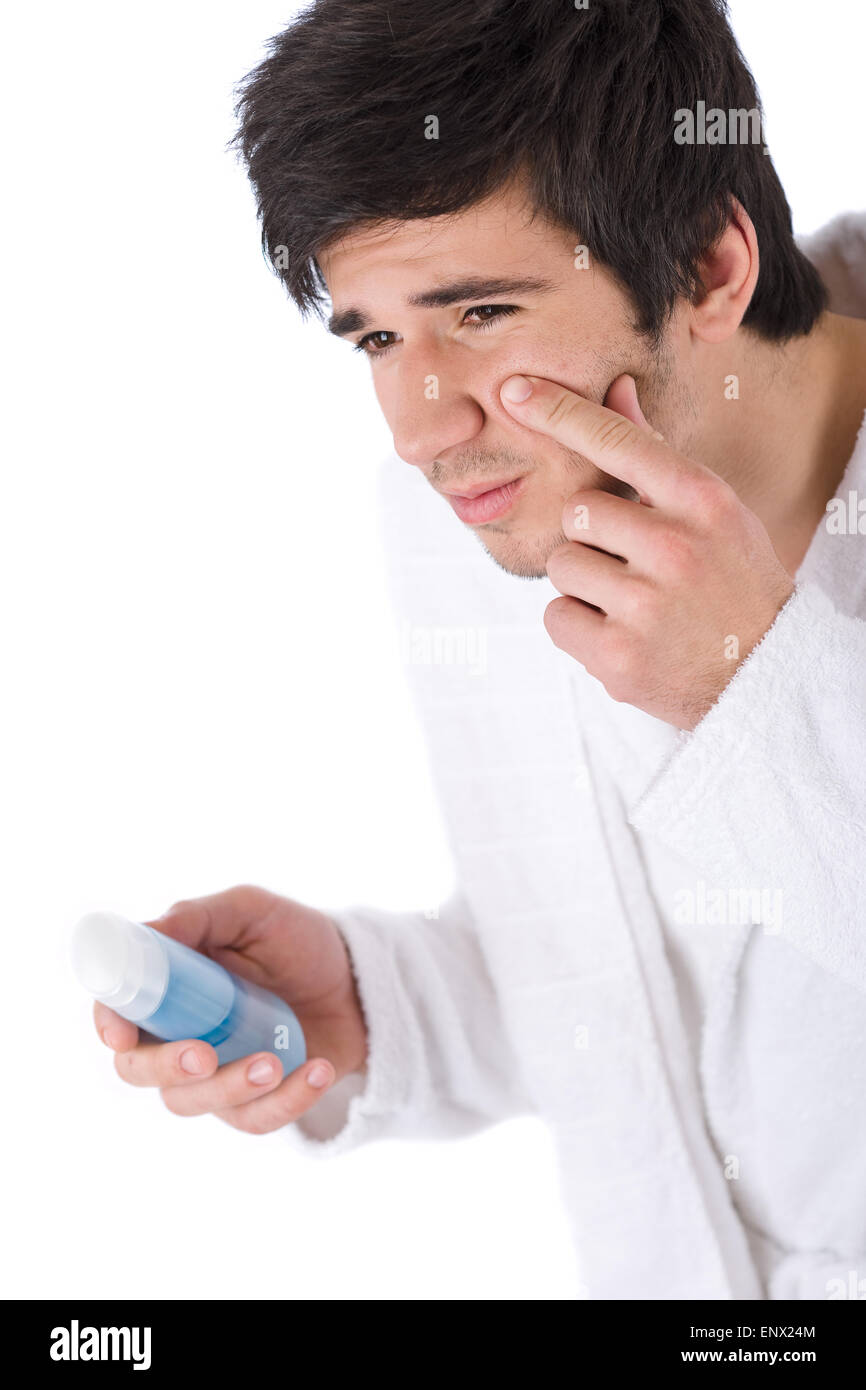 Facial care - Young man cleaning face with lotion Stock Photo - Alamy