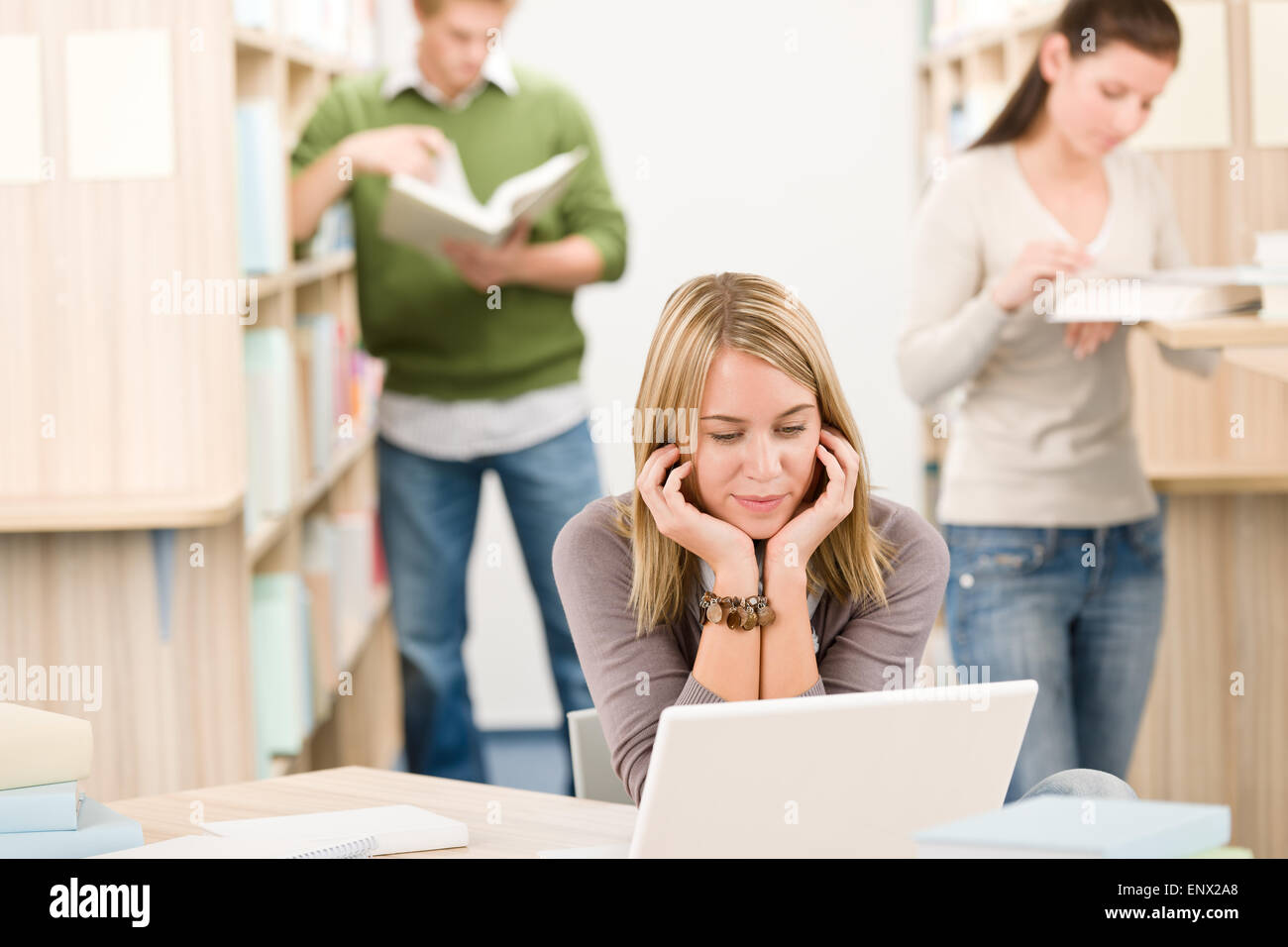 High school library - thoughtful student with laptop Stock Photo - Alamy