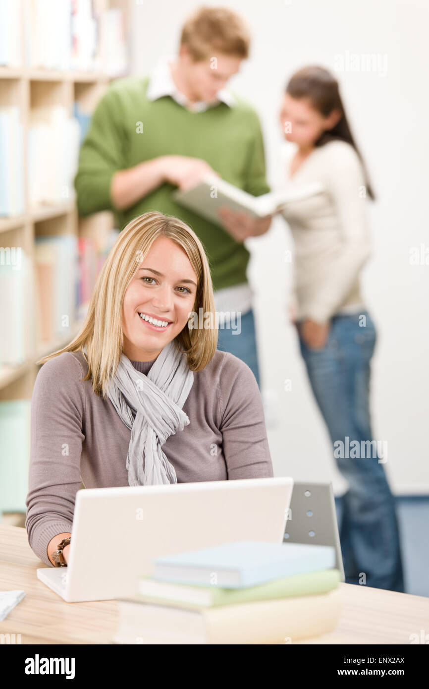High school library - happy student with laptop Stock Photo - Alamy