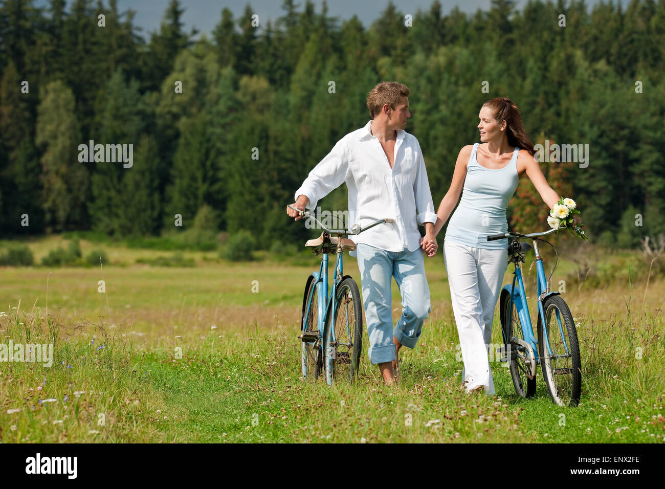 Romantic young couple with old bike in spring nature Stock Photo - Alamy