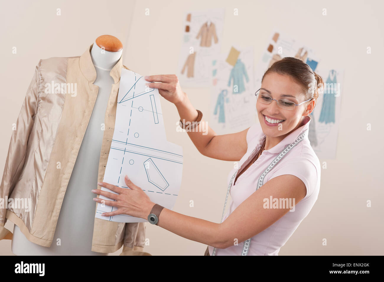 Female fashion designer working with pattern cutting Stock Photo - Alamy