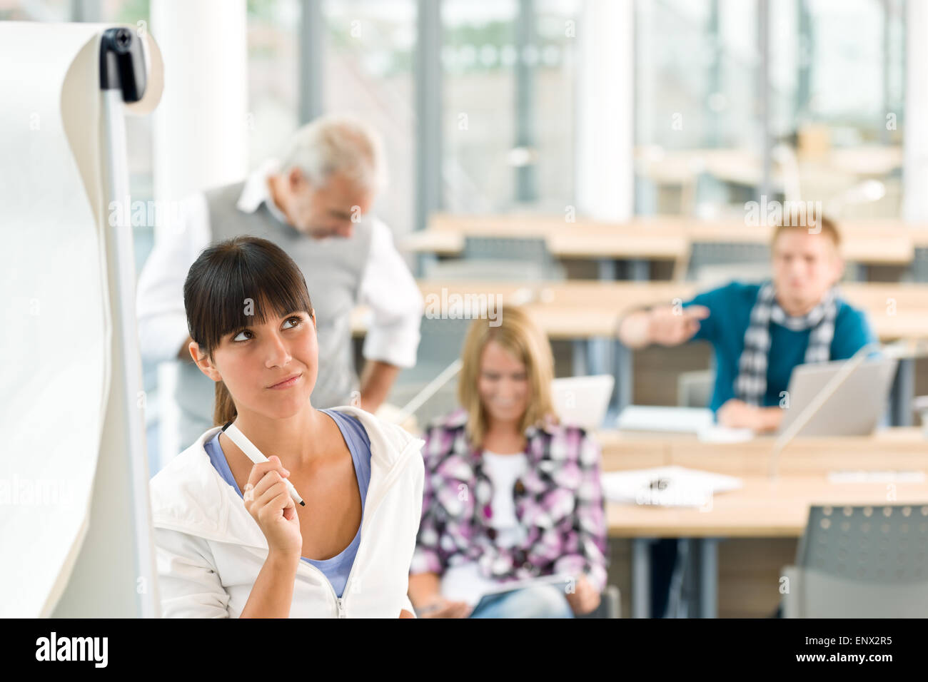 High school - three students with mature professor Stock Photo - Alamy