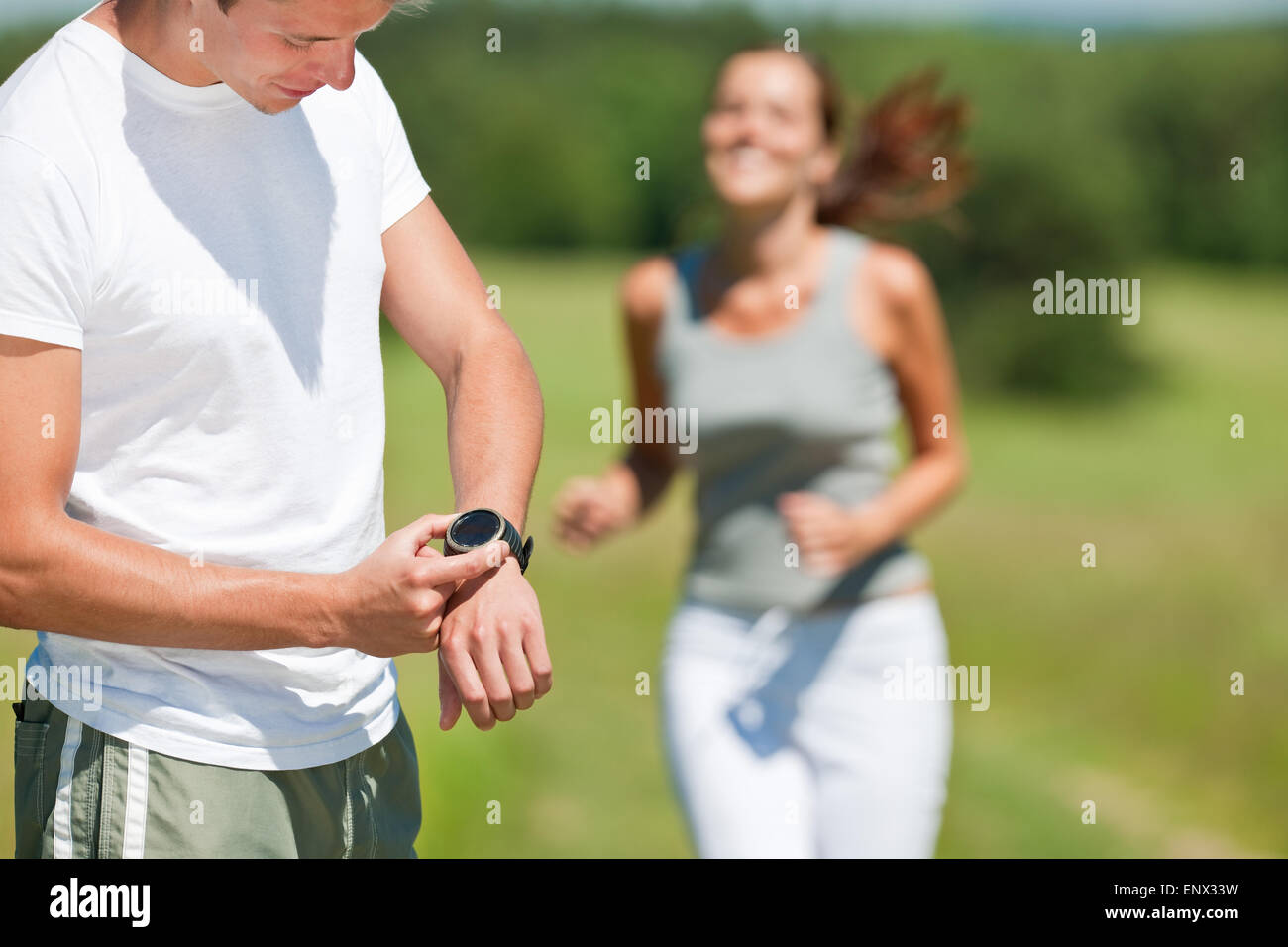 Young woman jogging stopwatch in hi-res stock photography and images ...