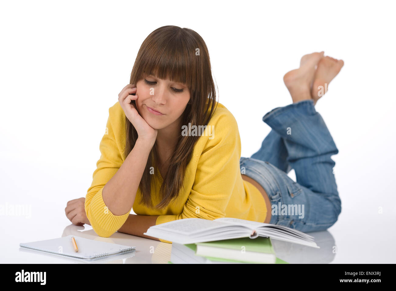 Student - Happy female teenager write homework think Stock Photo - Alamy