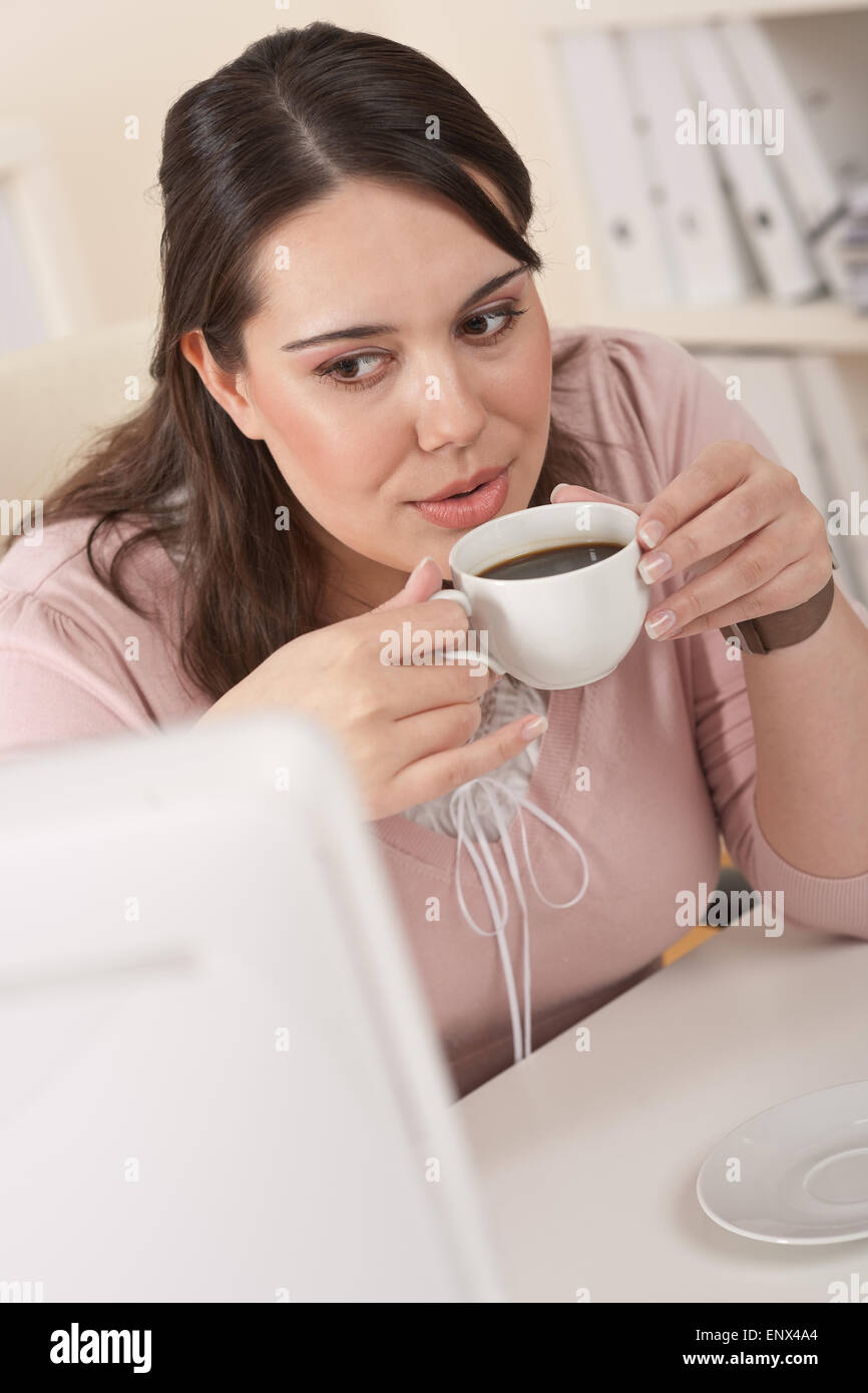 Young business woman enjoying coffee at modern office Stock Photo - Alamy