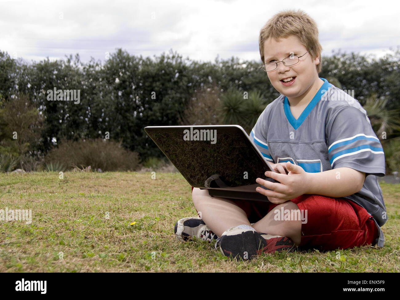 Smiling Boy Using a Computer Stock Photo - Alamy