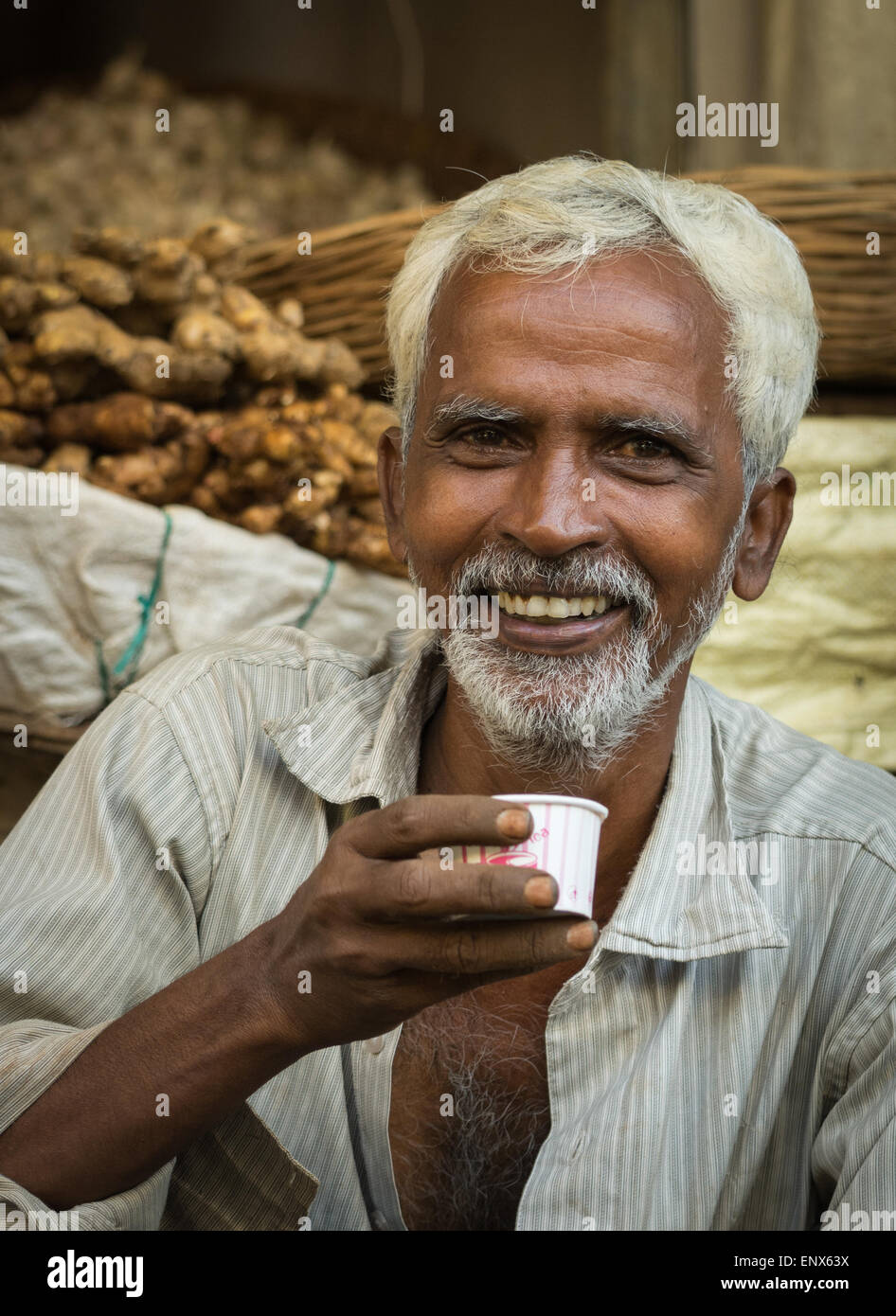 Portrait of a Indian vendor drinking tea in the vegetable market of ...