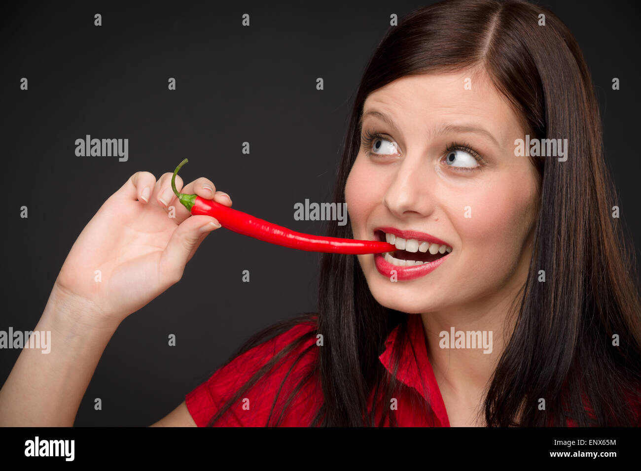 Chili pepper - portrait young woman red spicy Stock Photo - Alamy