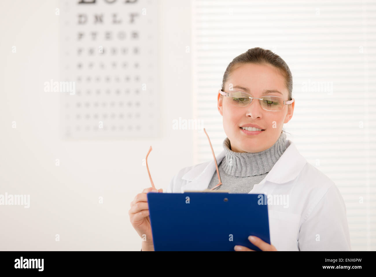 Optician doctor woman with glasses and eye chart Stock Photo - Alamy