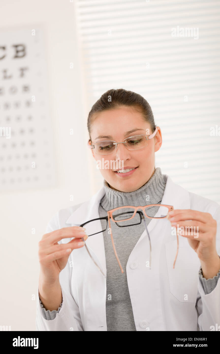 Optician doctor woman with glasses and eye chart Stock Photo - Alamy