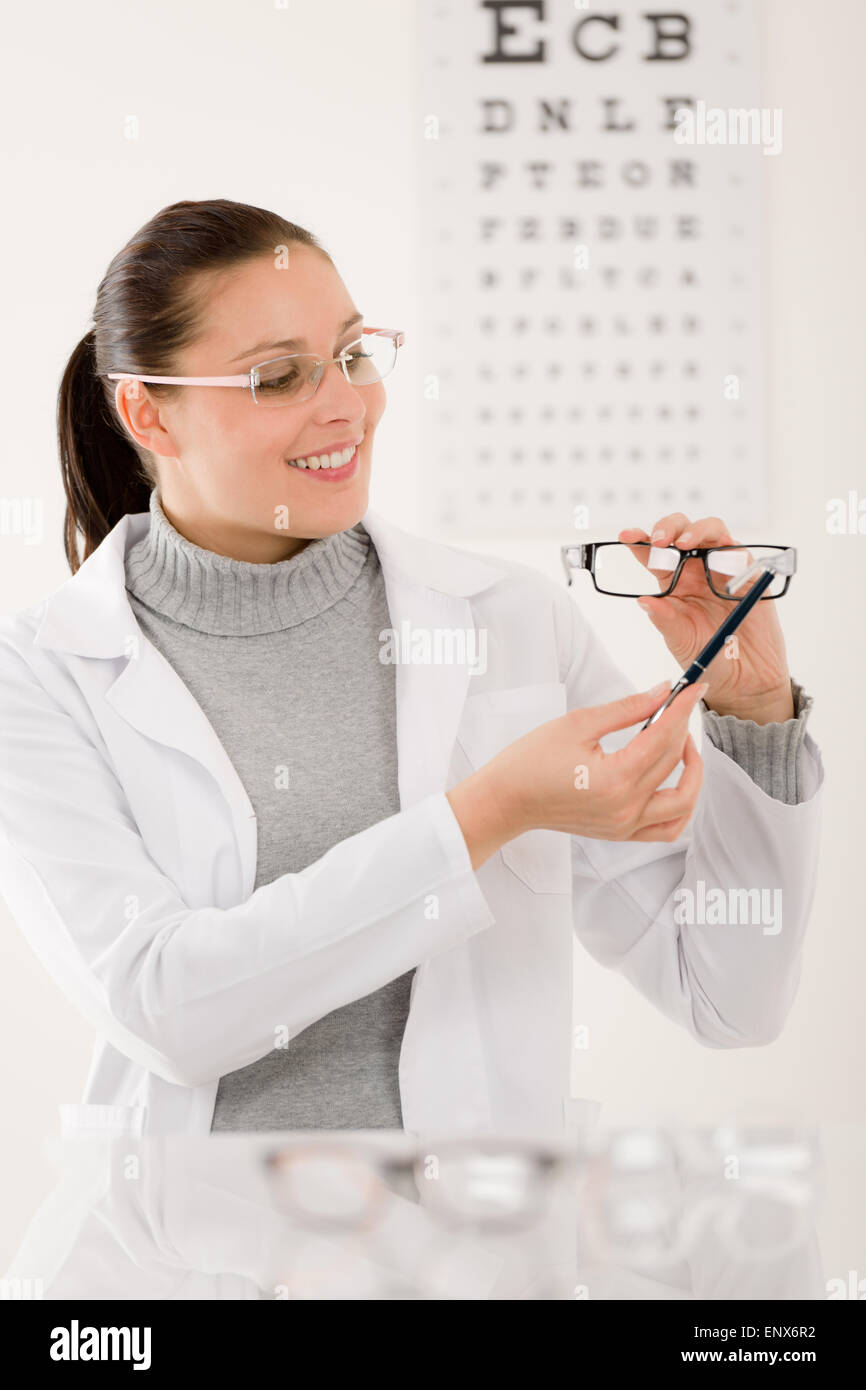 Optician doctor woman with glasses and eye chart Stock Photo - Alamy