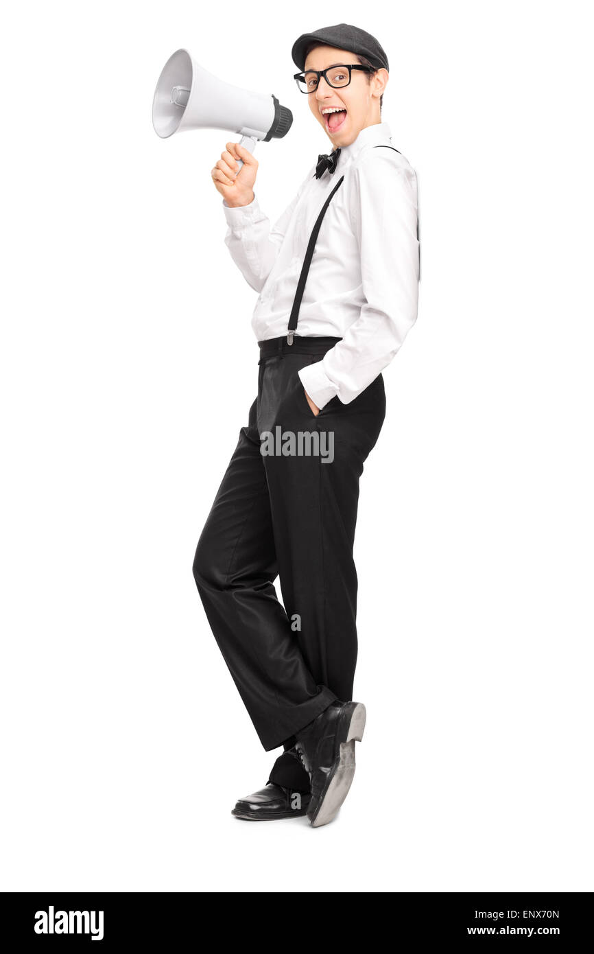 Full length portrait of a young artistic man speaking on a megaphone ...