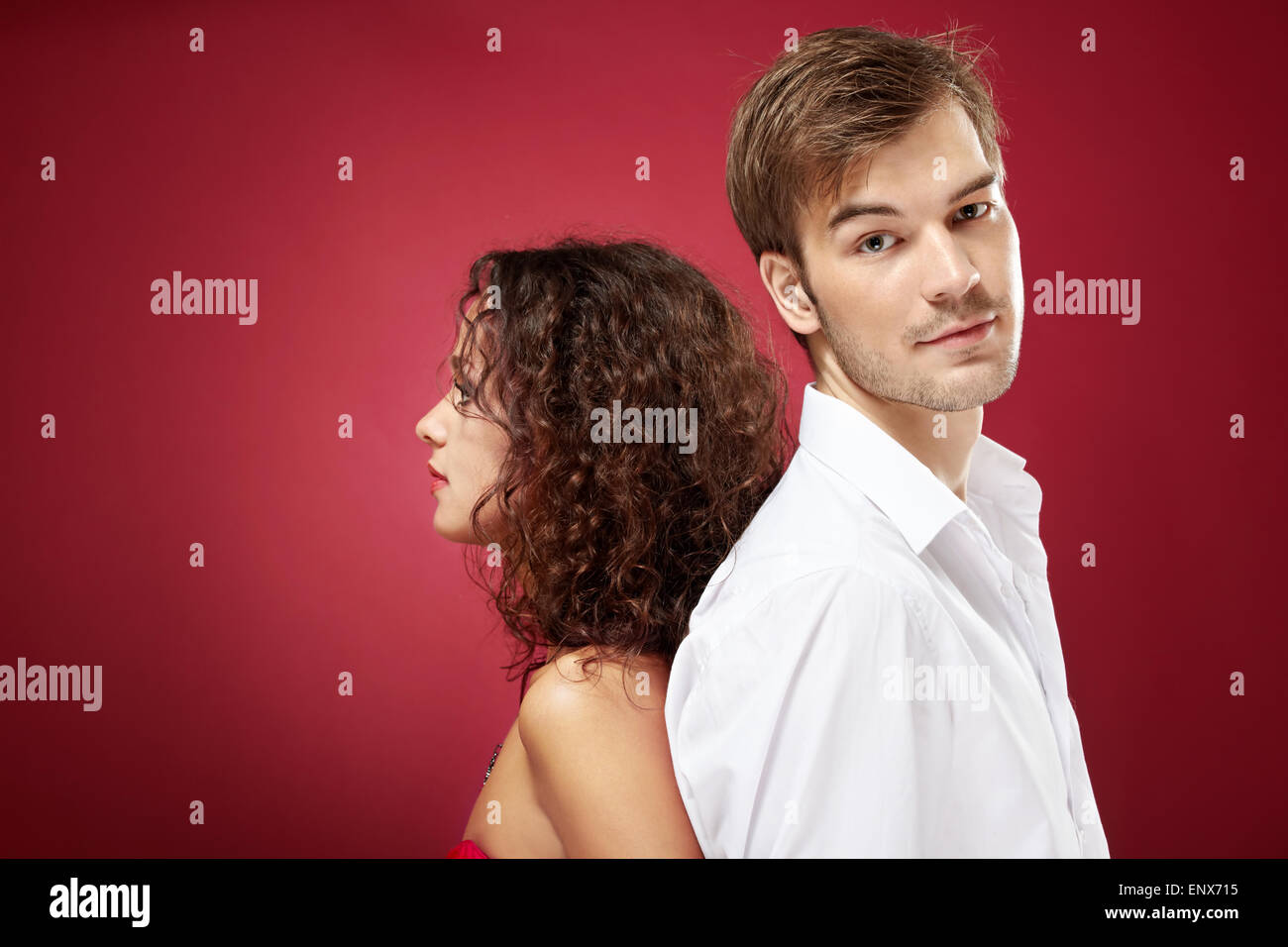 Young man and woman stand a back to each other Stock Photo - Alamy