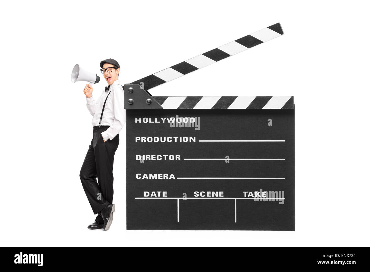 Young movie director speaking on a megaphone and leaning on a giant ...