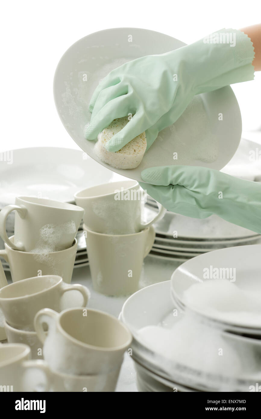 Washing dishes - hands with gloves in kitchen Stock Photo - Alamy