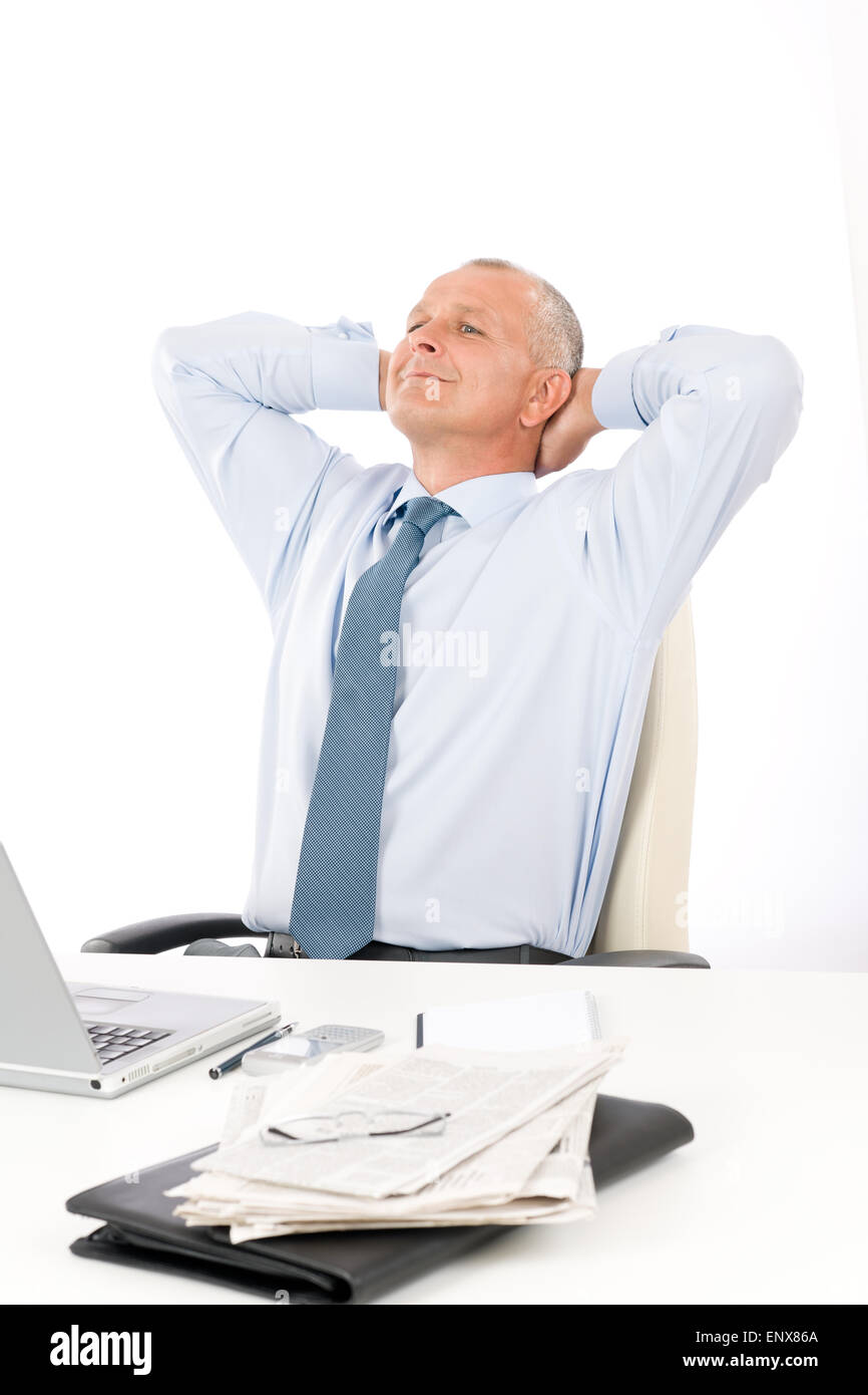 Happy businessman relaxing in office behind desk Stock Photo - Alamy