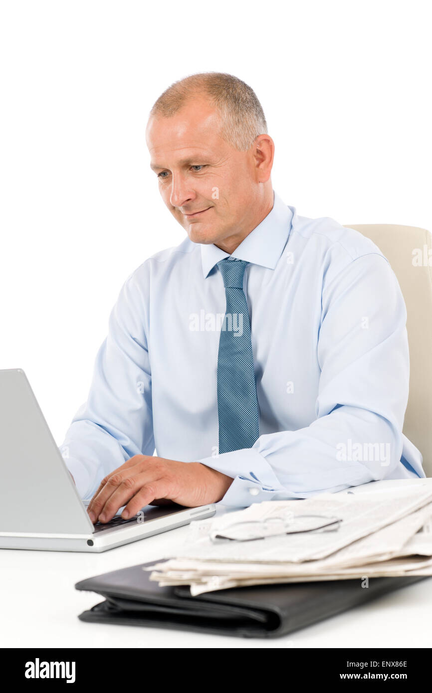 Happy businessman working in office behind desk Stock Photo - Alamy