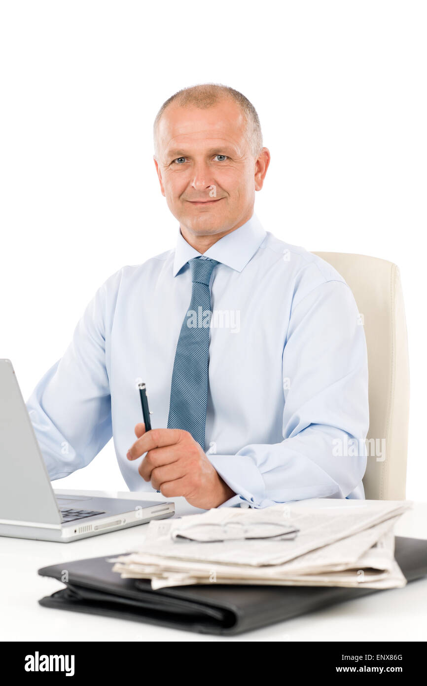 Happy businessman working in office behind desk Stock Photo - Alamy