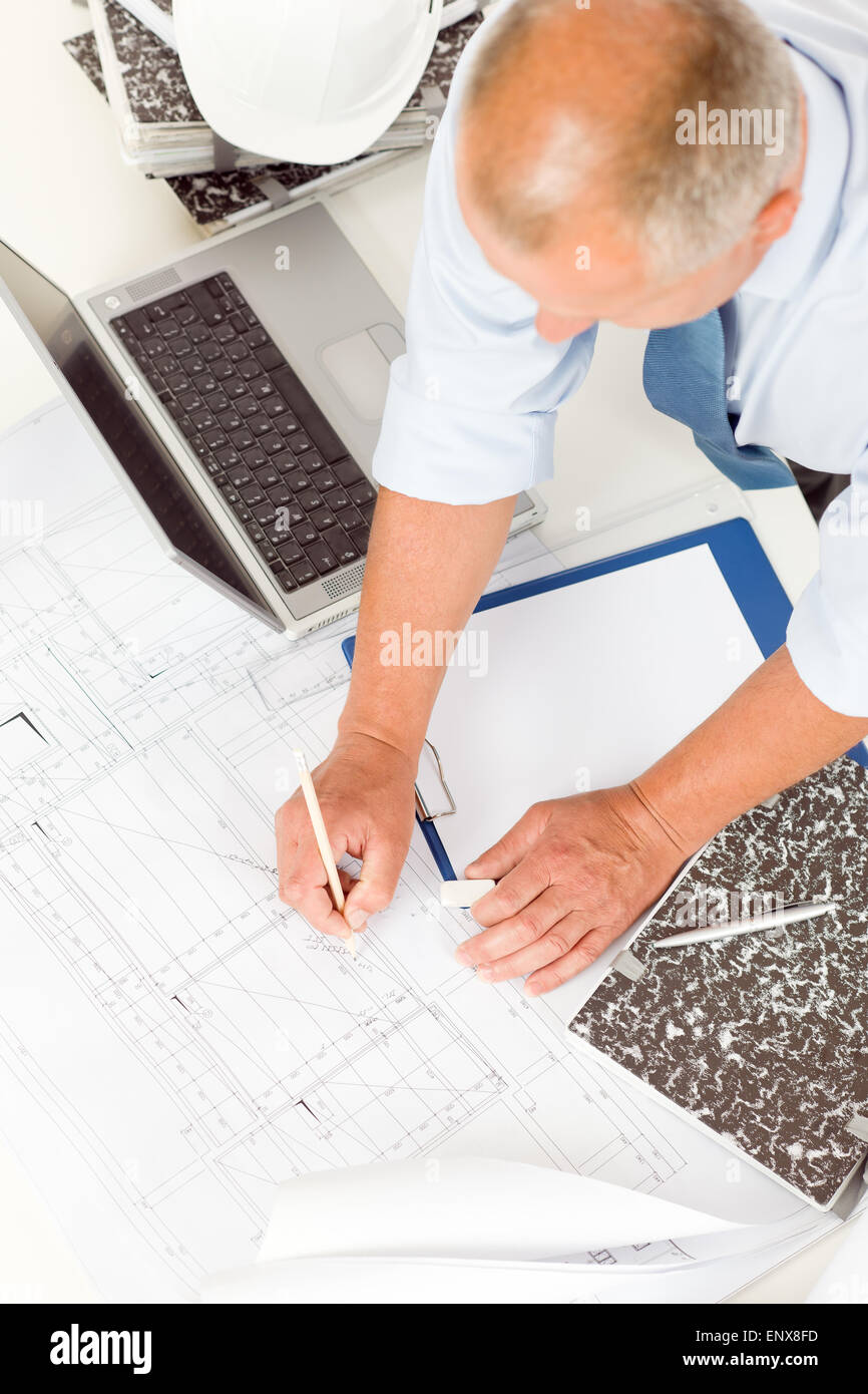 Senior man work on blueprints construction plans Stock Photo - Alamy