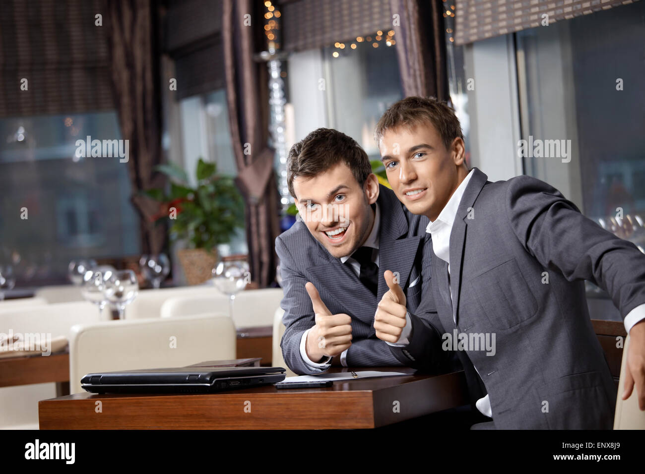 Two joyful businessmen at restaurant celebrate the transaction Stock ...
