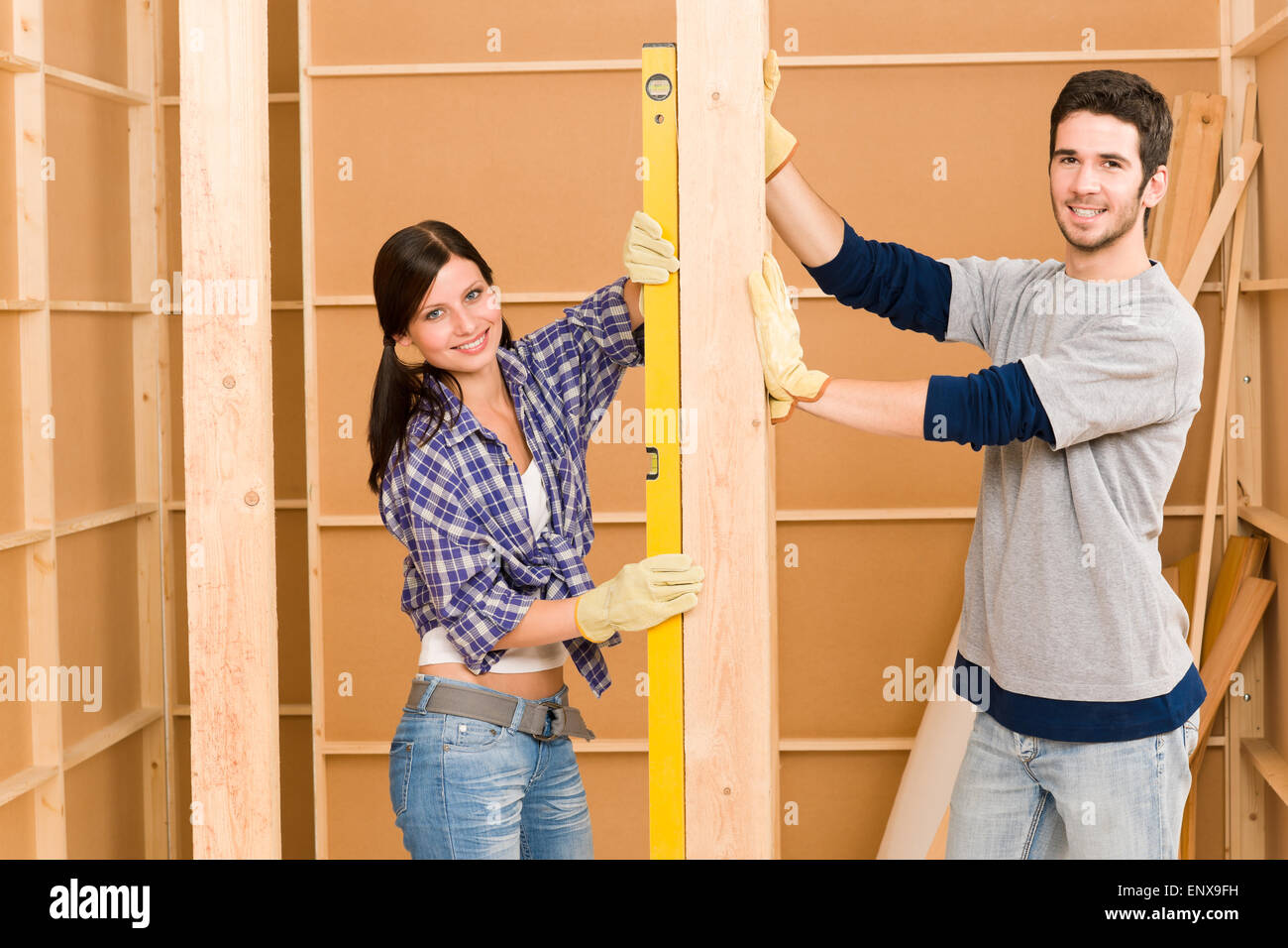 Home improvement smiling couple with spirit level Stock Photo - Alamy