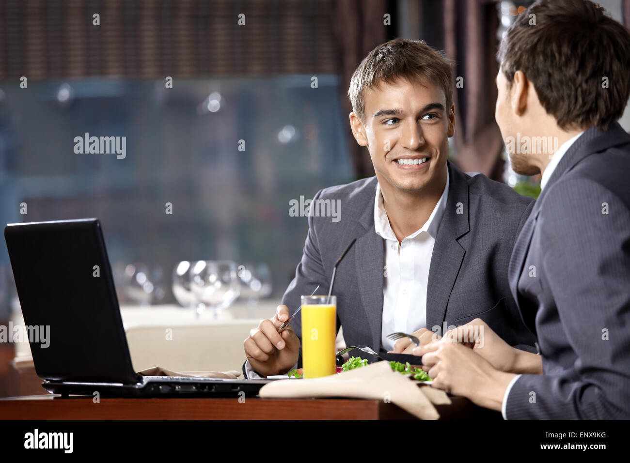 Two young businessmen have supper at restaurant Stock Photo - Alamy