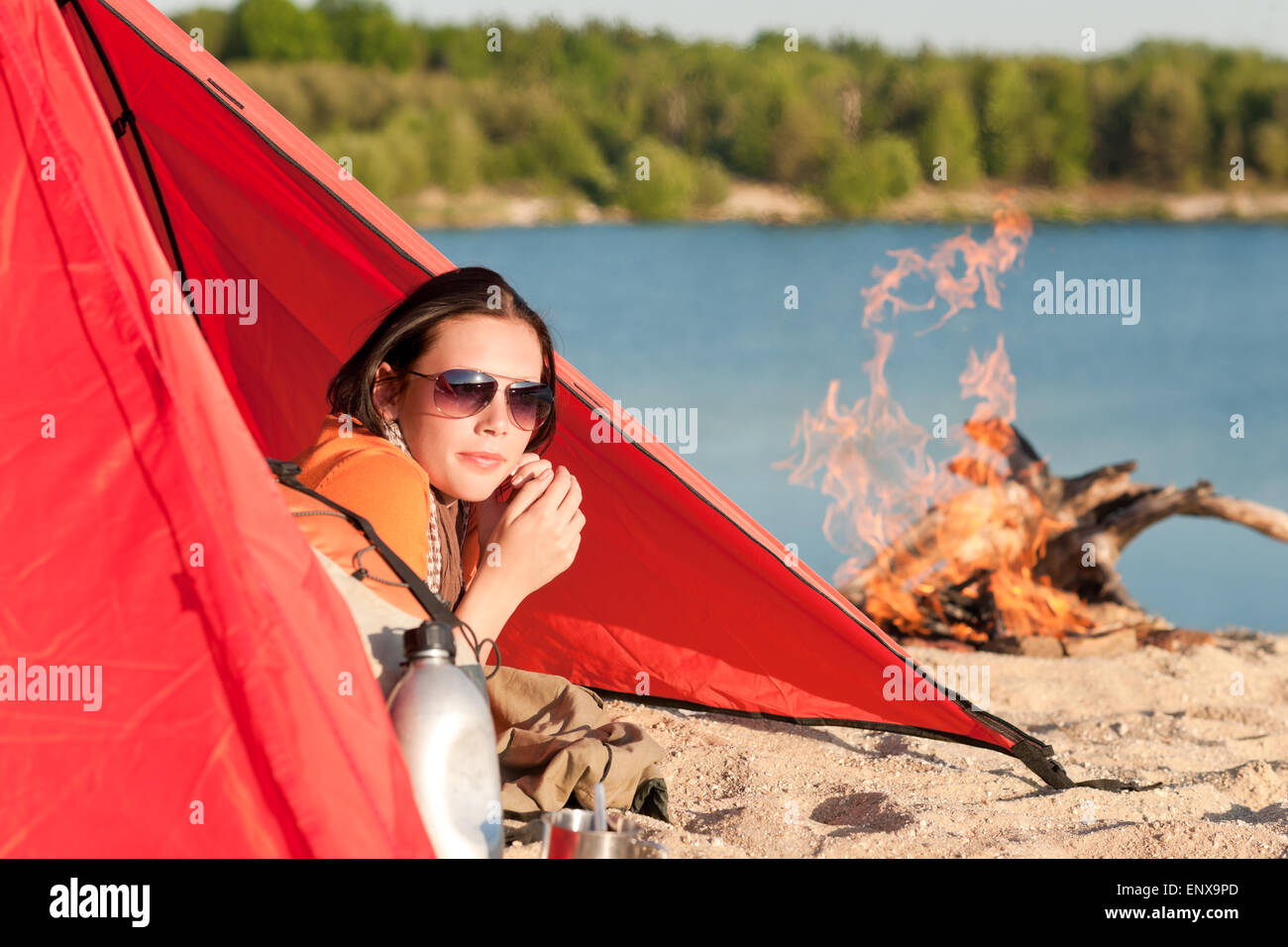 Camping happy woman relax in tent by campfire Stock Photo - Alamy